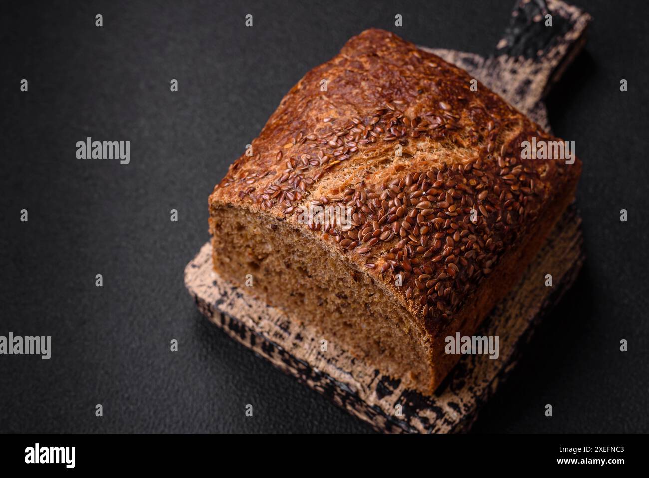 Delicious fresh crispy brown bread with grains and seeds Stock Photo ...