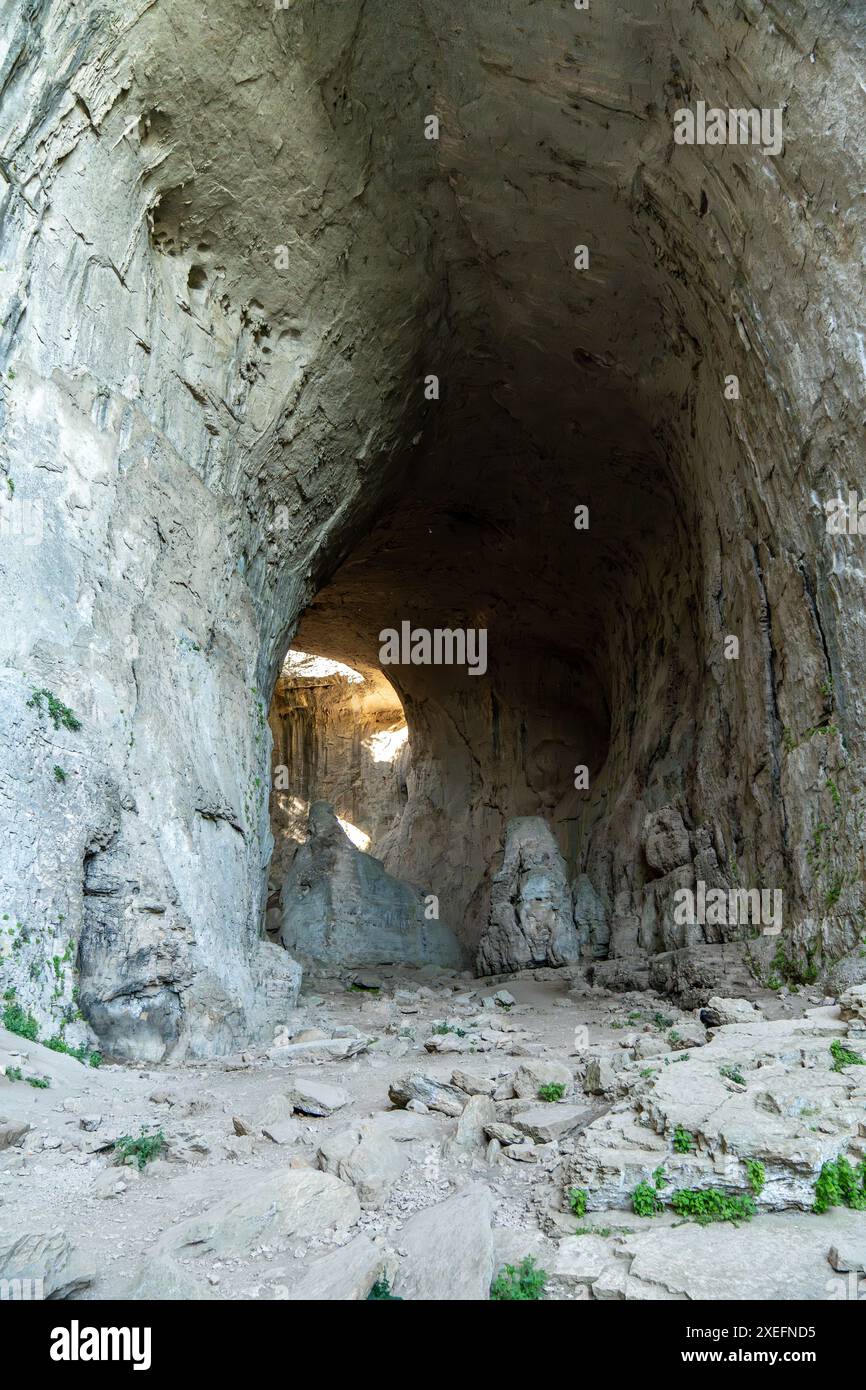 Large natural cave opening showing sunlight shining through from ...