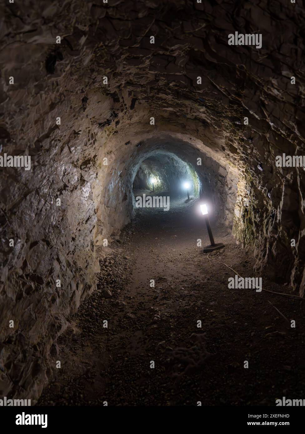Narrow underground tunnel system illuminating with artificial white ...