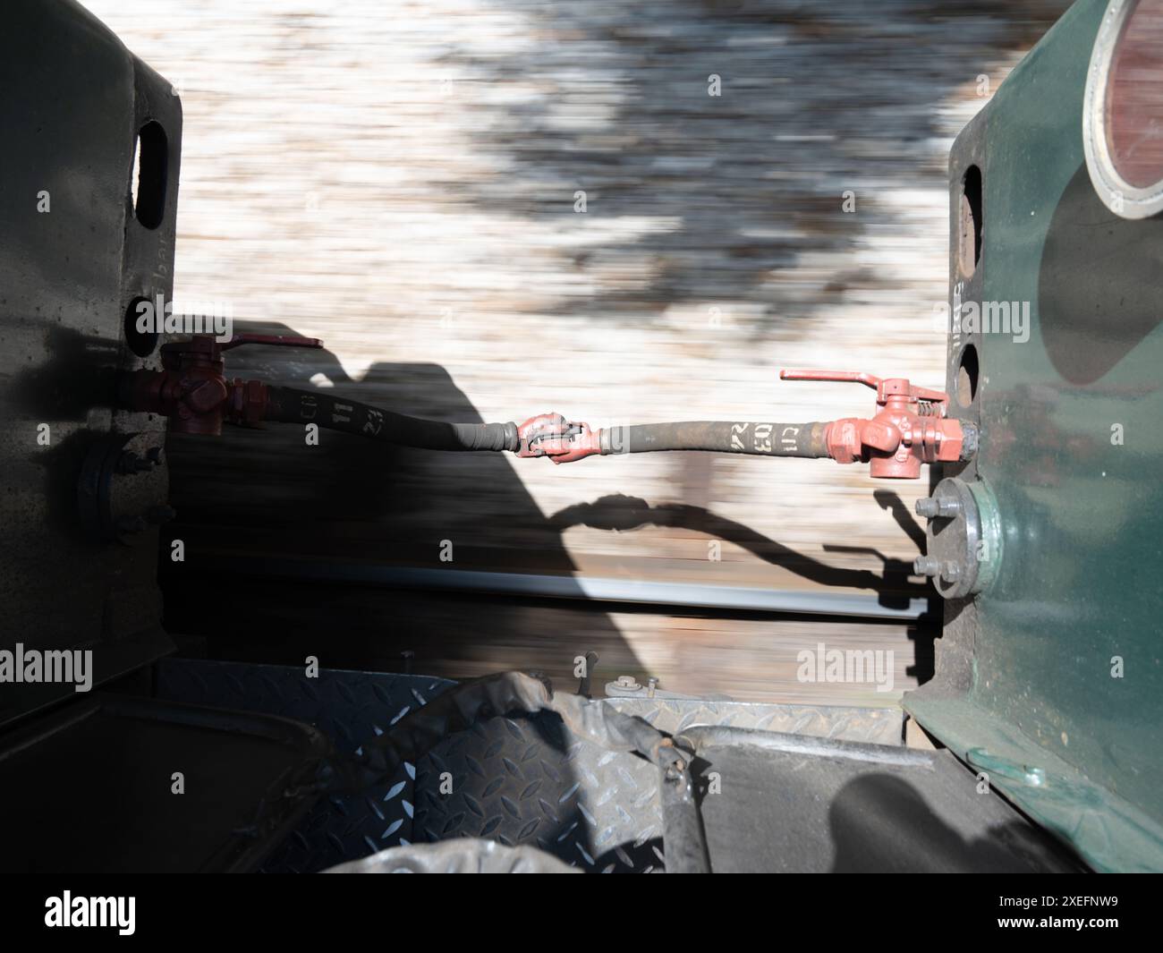 Train coupling mechanism connecting train wagons is visible from open ...