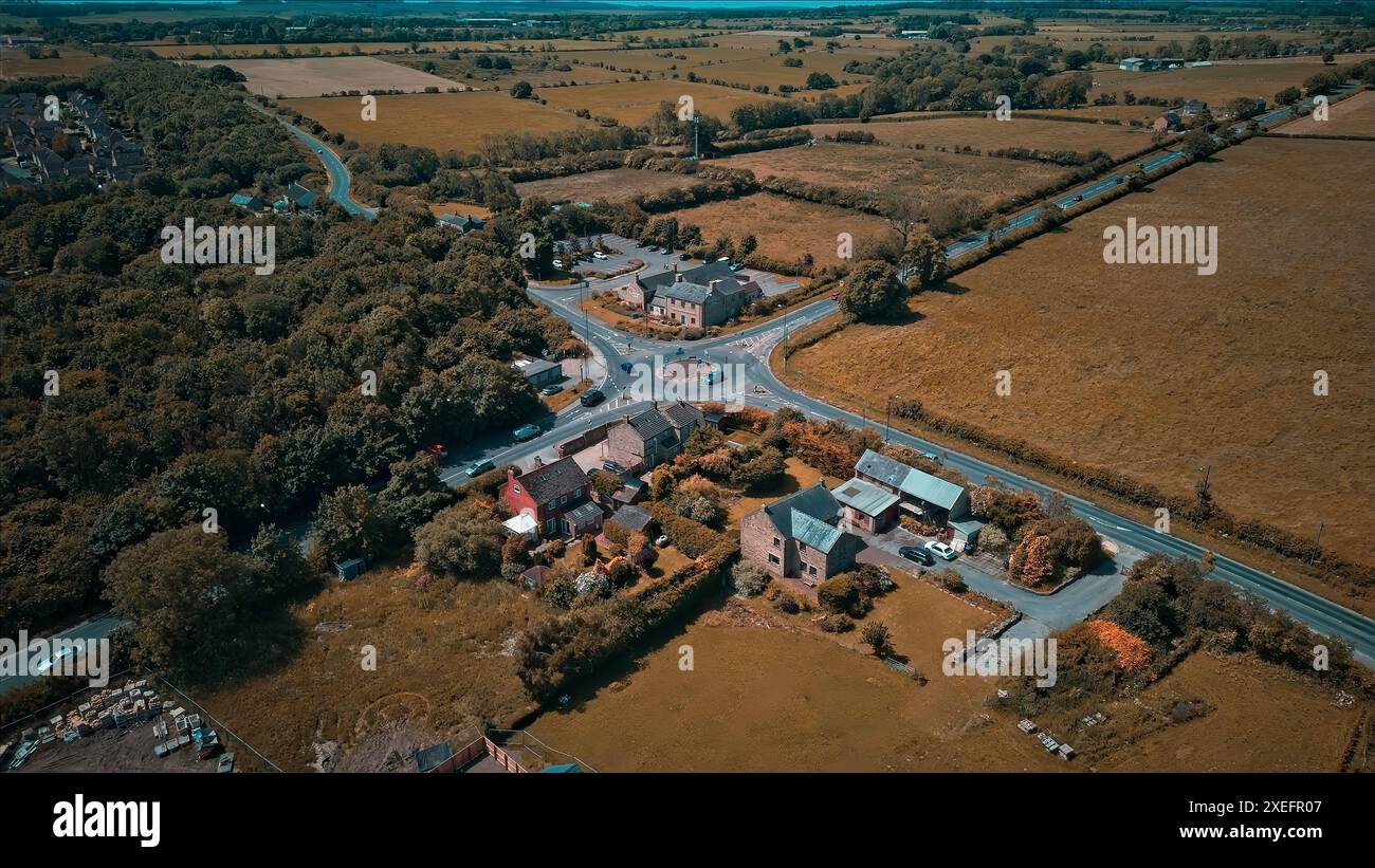 Aerial view of a rural area with houses, roads, and fields. The ...