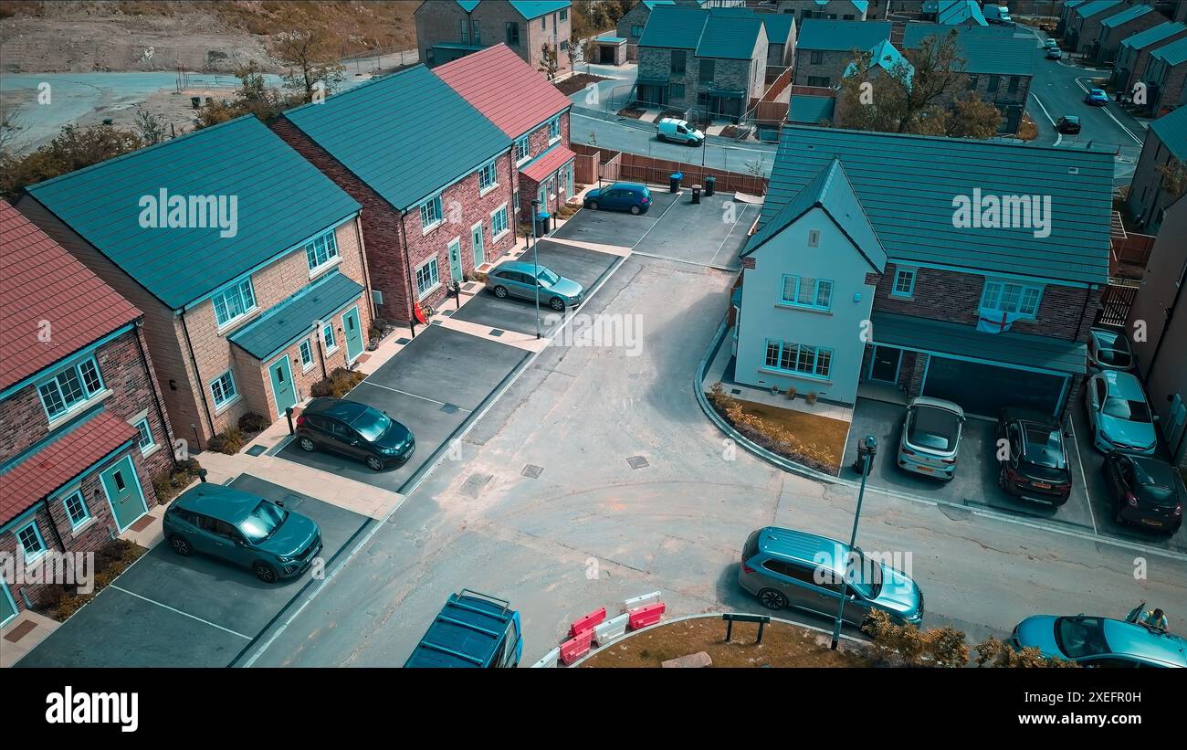 Aerial view of a suburban neighborhood with modern houses, parked cars ...