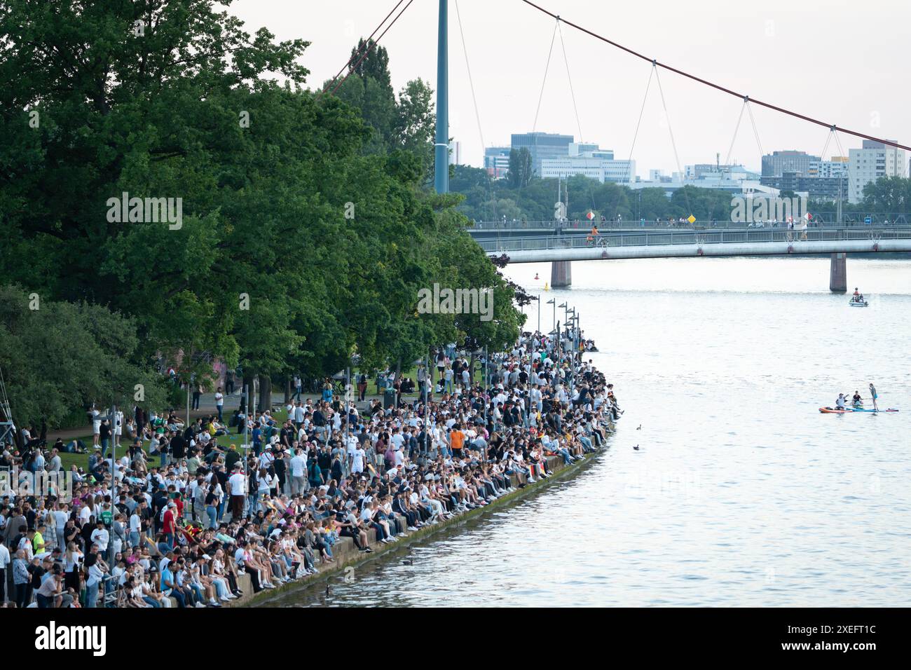 A large crowd of people gathered along the riverside during UEFA EURO ...