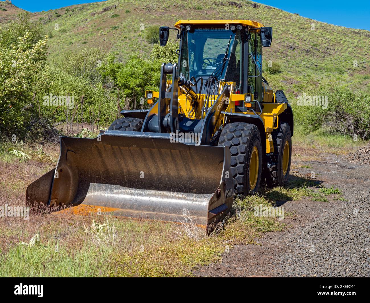 A John Deere wheel loader parked in the grass near Oxbow, Oregon, USA ...