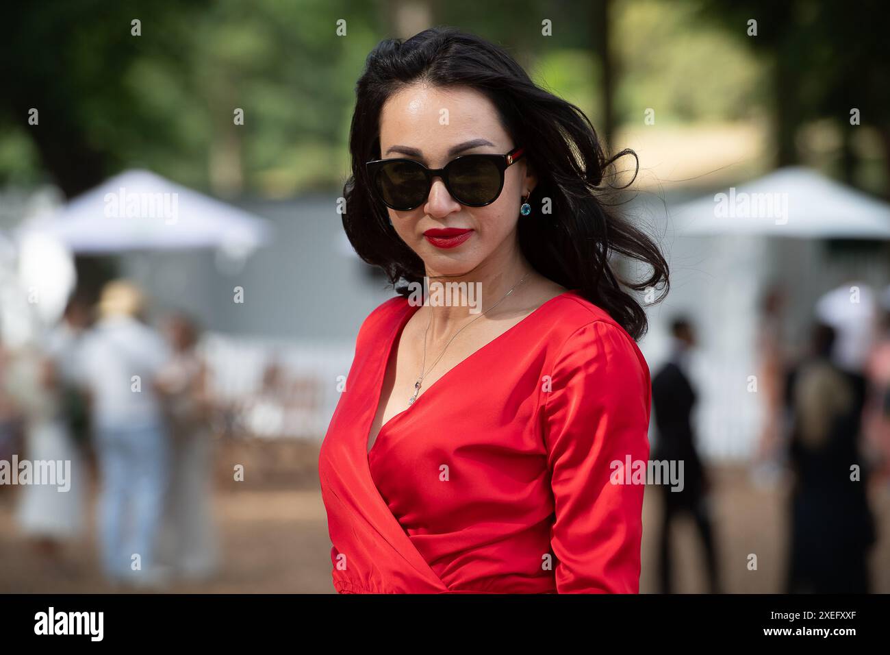 Stoke Poges, UK. 27th June, 2024. Alona Kueus wears a red dress to the ...