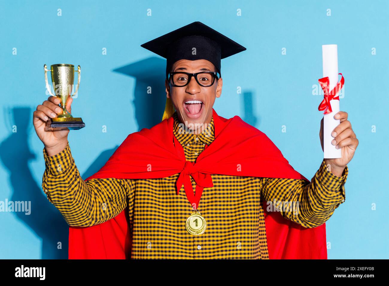 Photo of attractive young man hold diploma golden goblet graduation hat ...