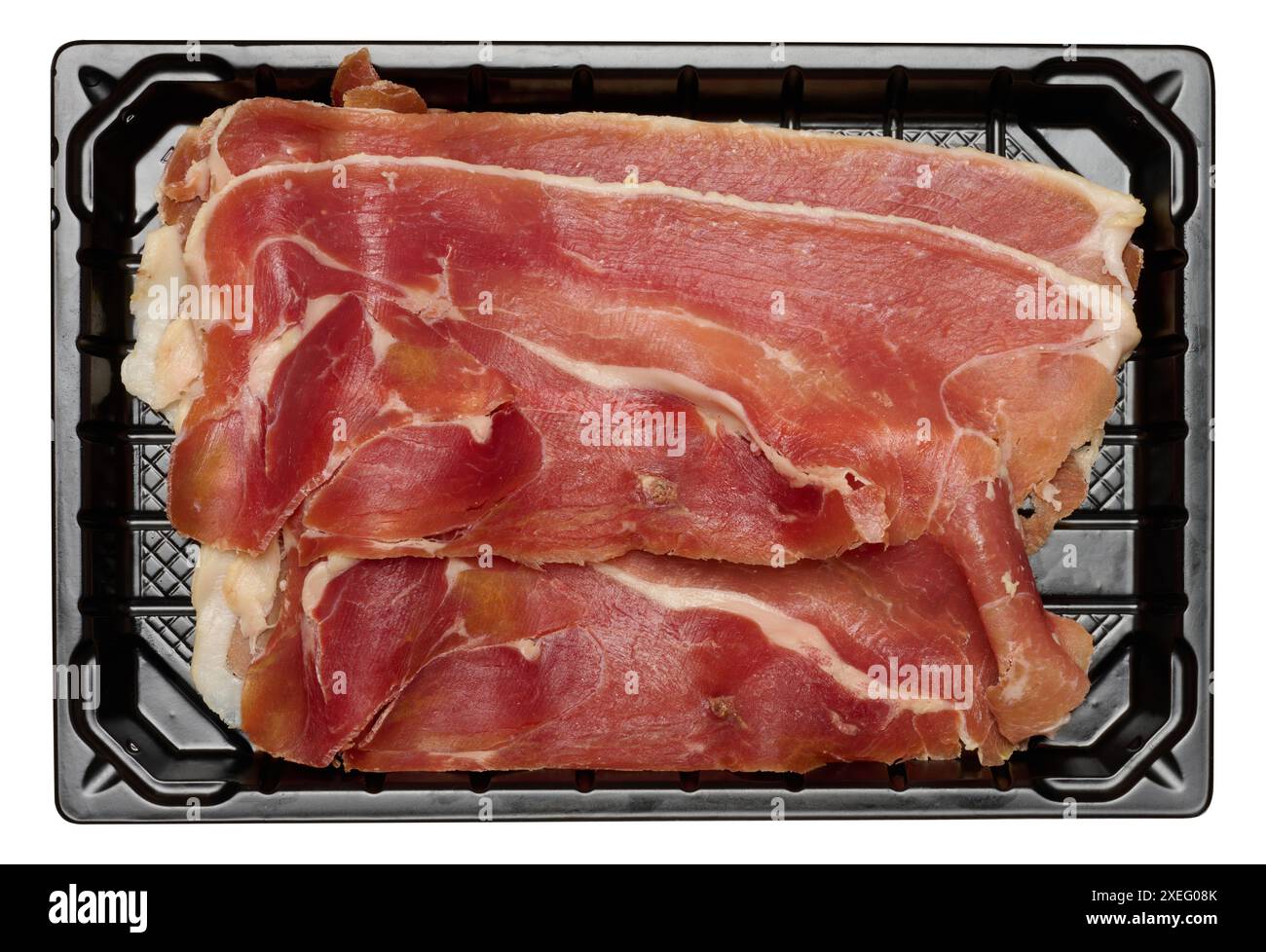 Thinly sliced jamon in a plastic container on an isolated background ...