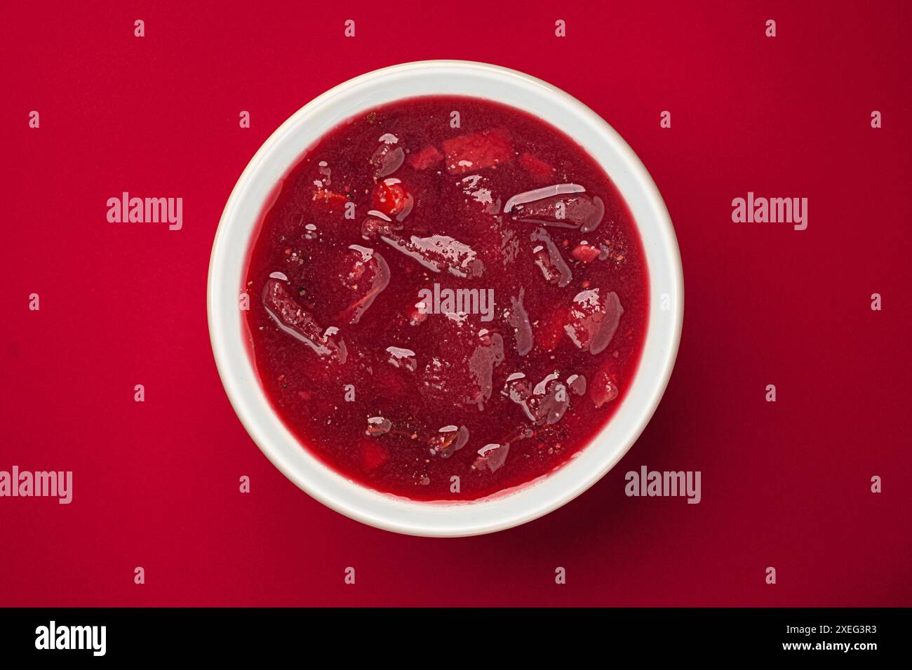 Traditional borscht, beetroot soup on red background with copy space ...