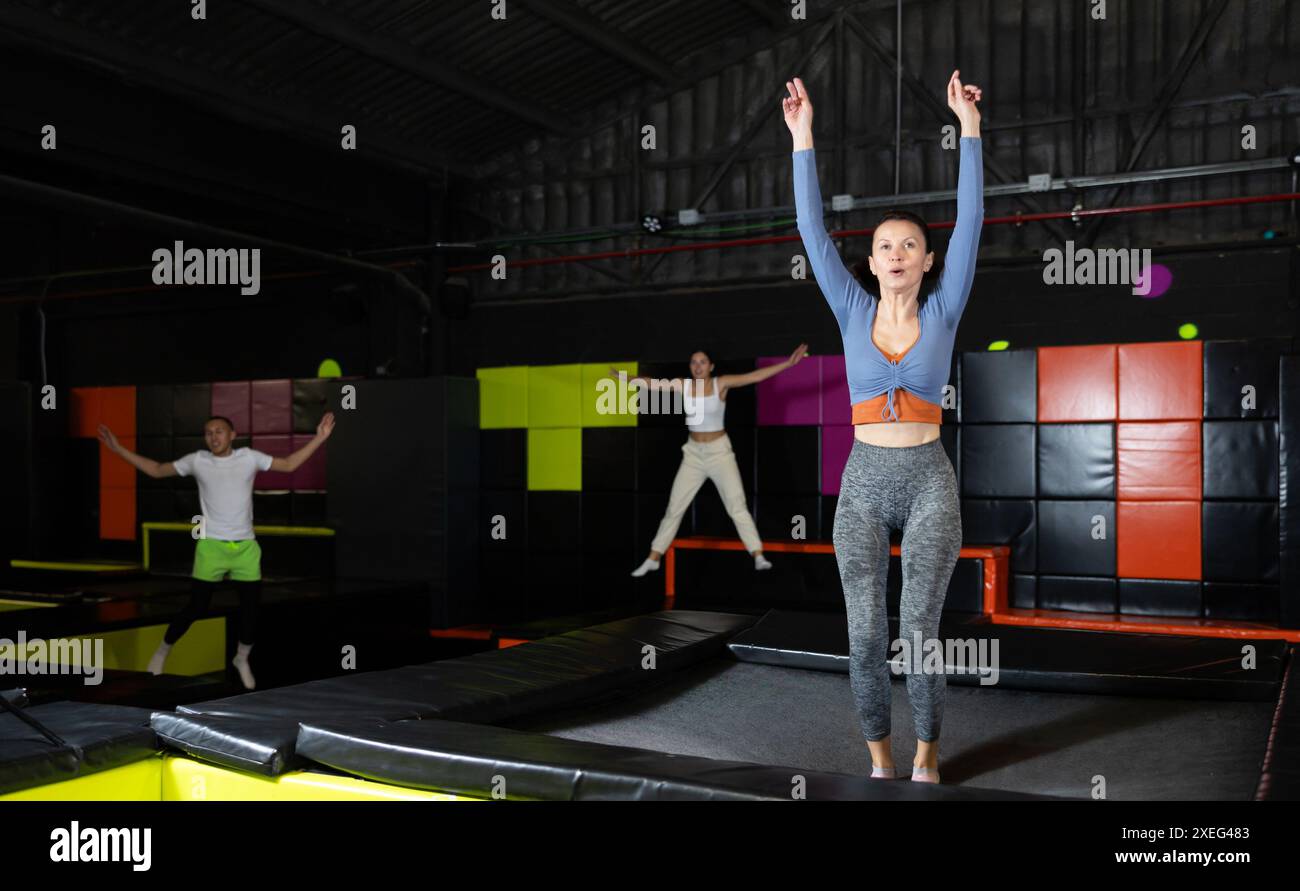 Cheerful woman jumping at modern colorful trampoline park Stock Photo ...