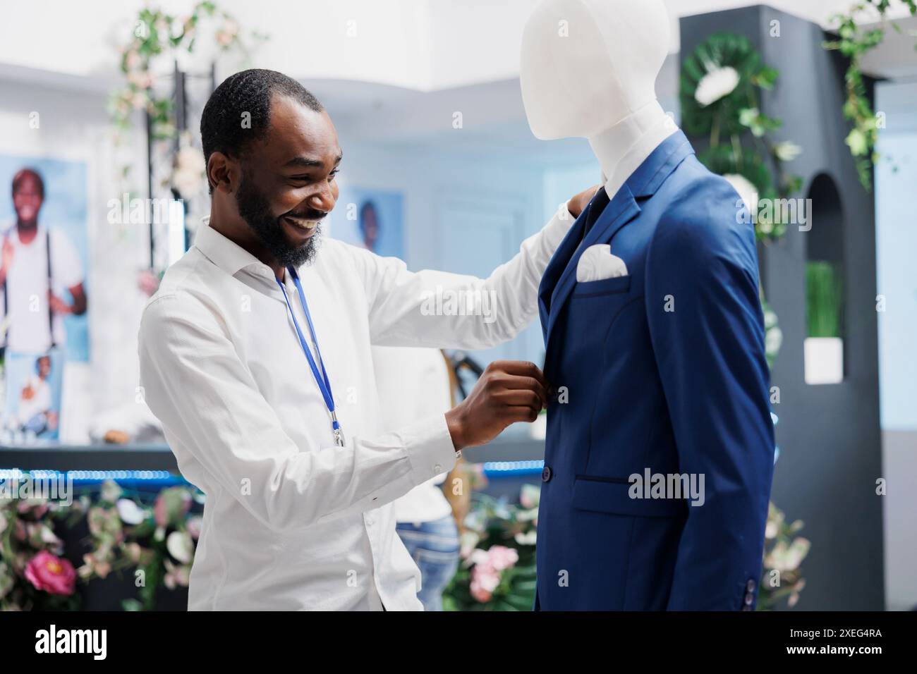 Boutique assistant fastening buttons on mannequin wearing formal jacket ...