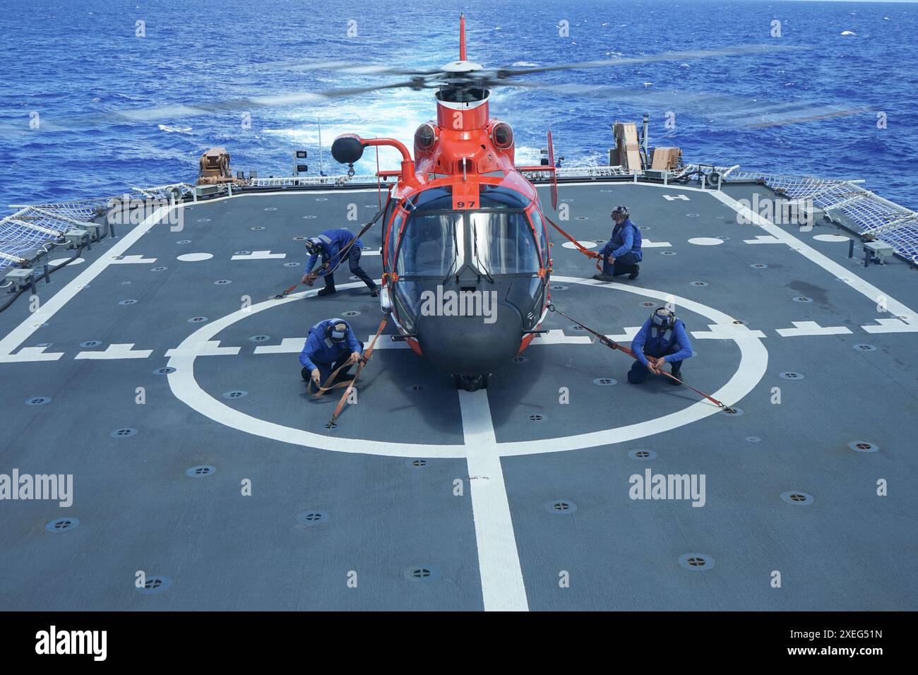 Coast Guard Cutter Stone (WMSL 758) personnel assist an embarked Coast ...