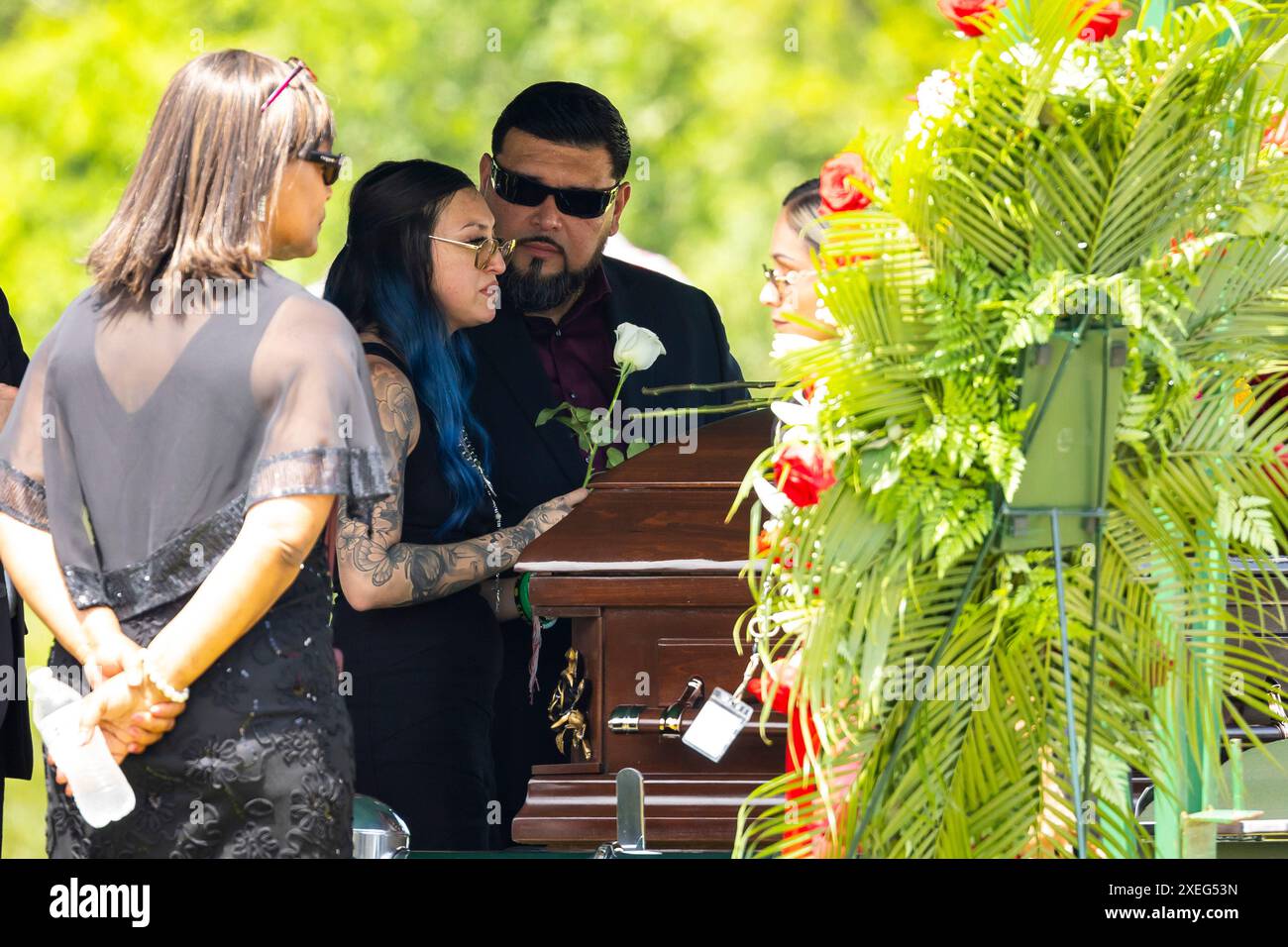 Alexis Nungaray places a white rose on the casket of her 12-year-old ...
