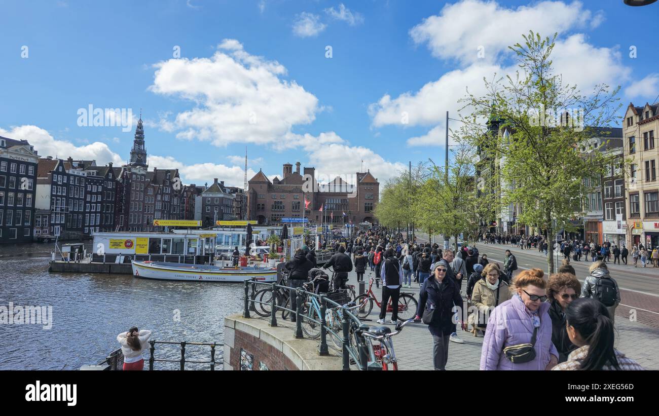 A diverse group of people stroll down a charming street beside a ...
