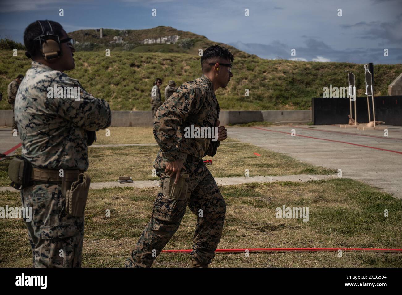 U.S. Marine Corps Sgt. Guadalupe Campos Jr. draws an M9 pistol during a ...