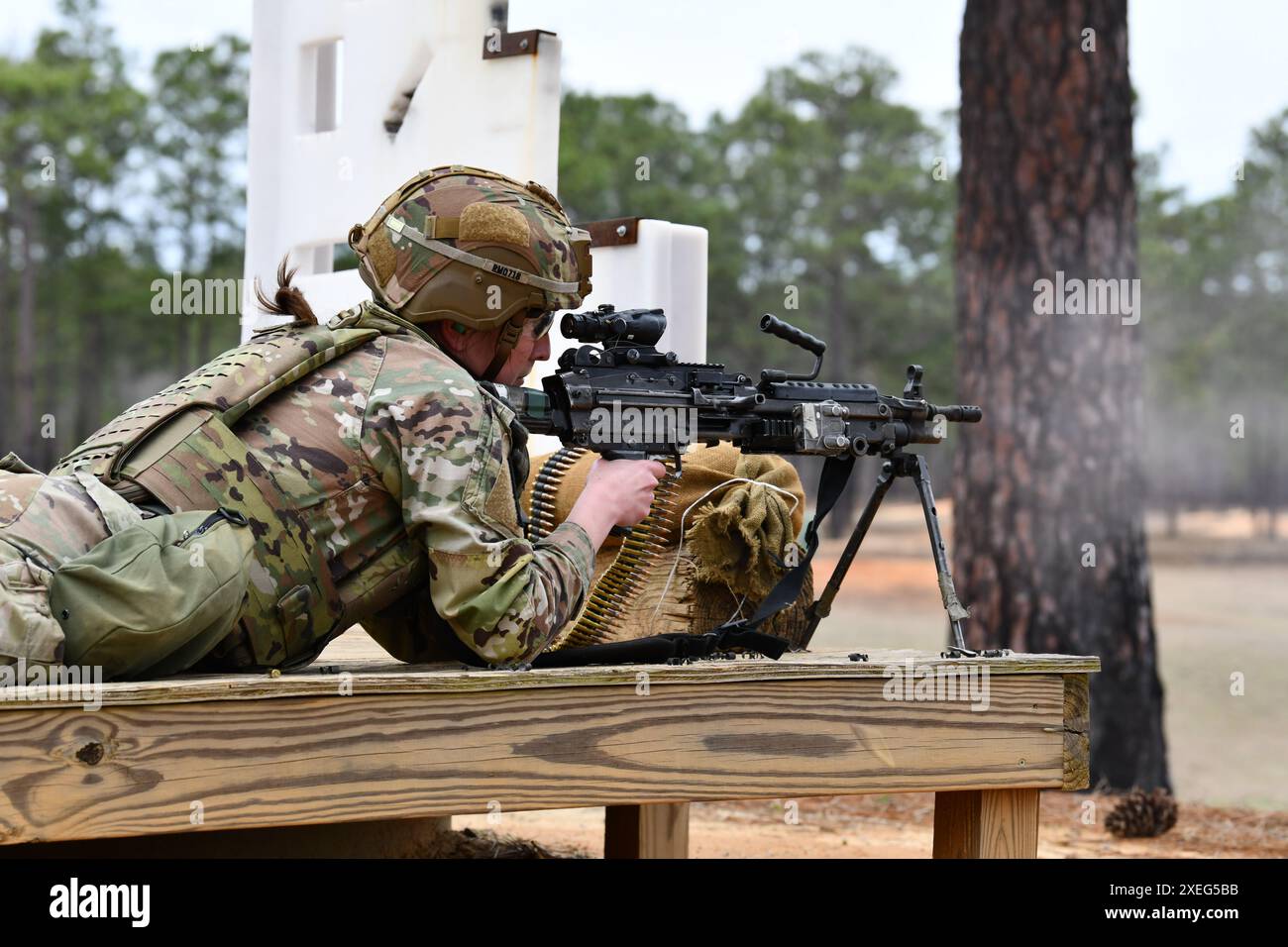A 68W Combat Medic fires a M249 light machine gun from prone position ...