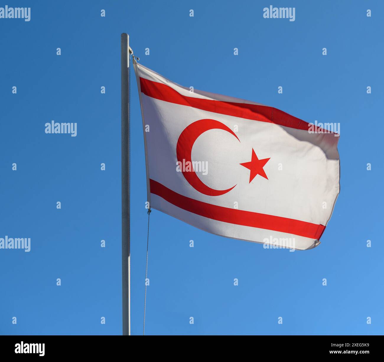 flag of the Turkish Republic of Northern Cyprus against a blue sky ...