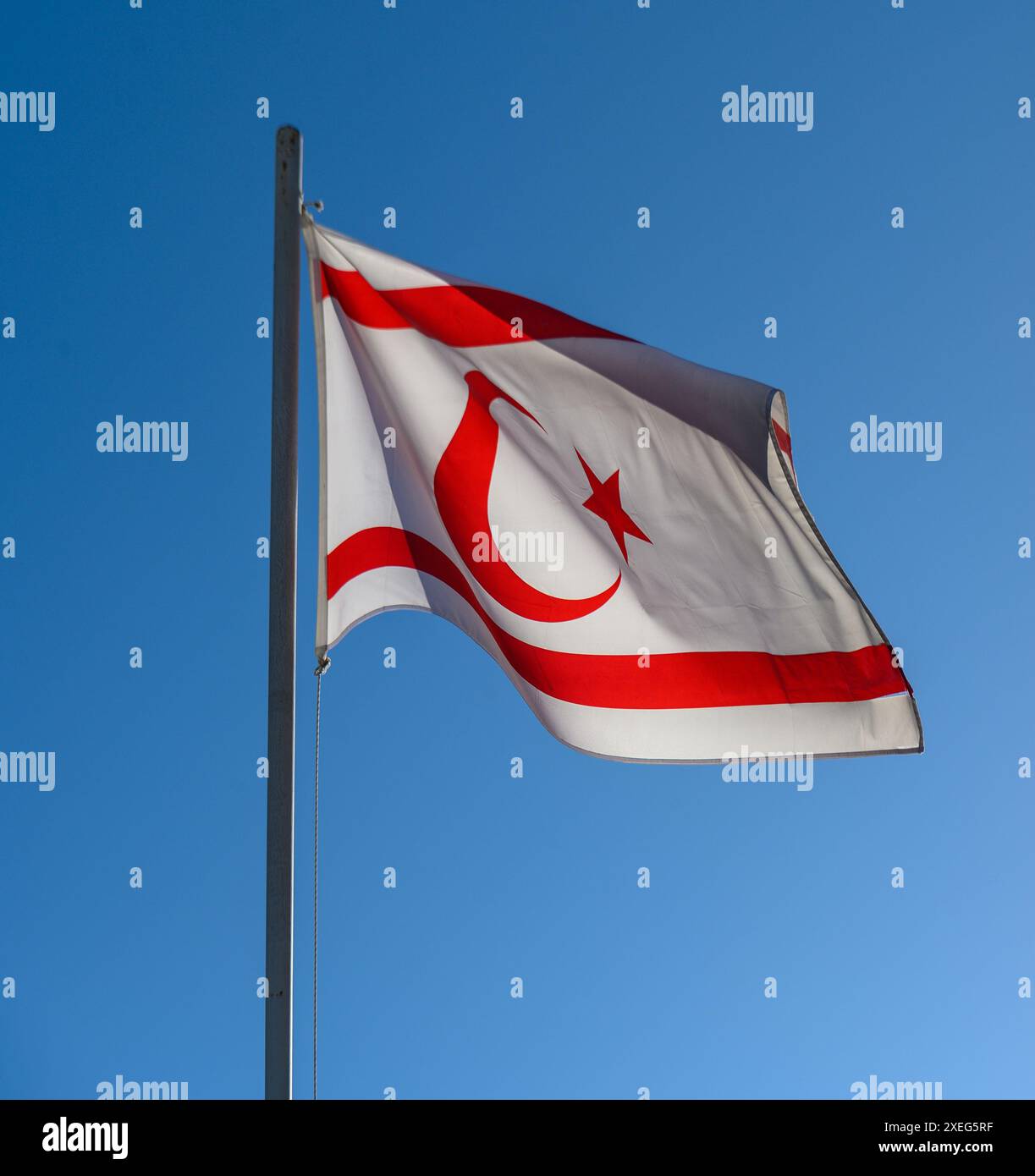 Flag of Turkish Republic of Northern Cyprus on blue sky with clouds ...