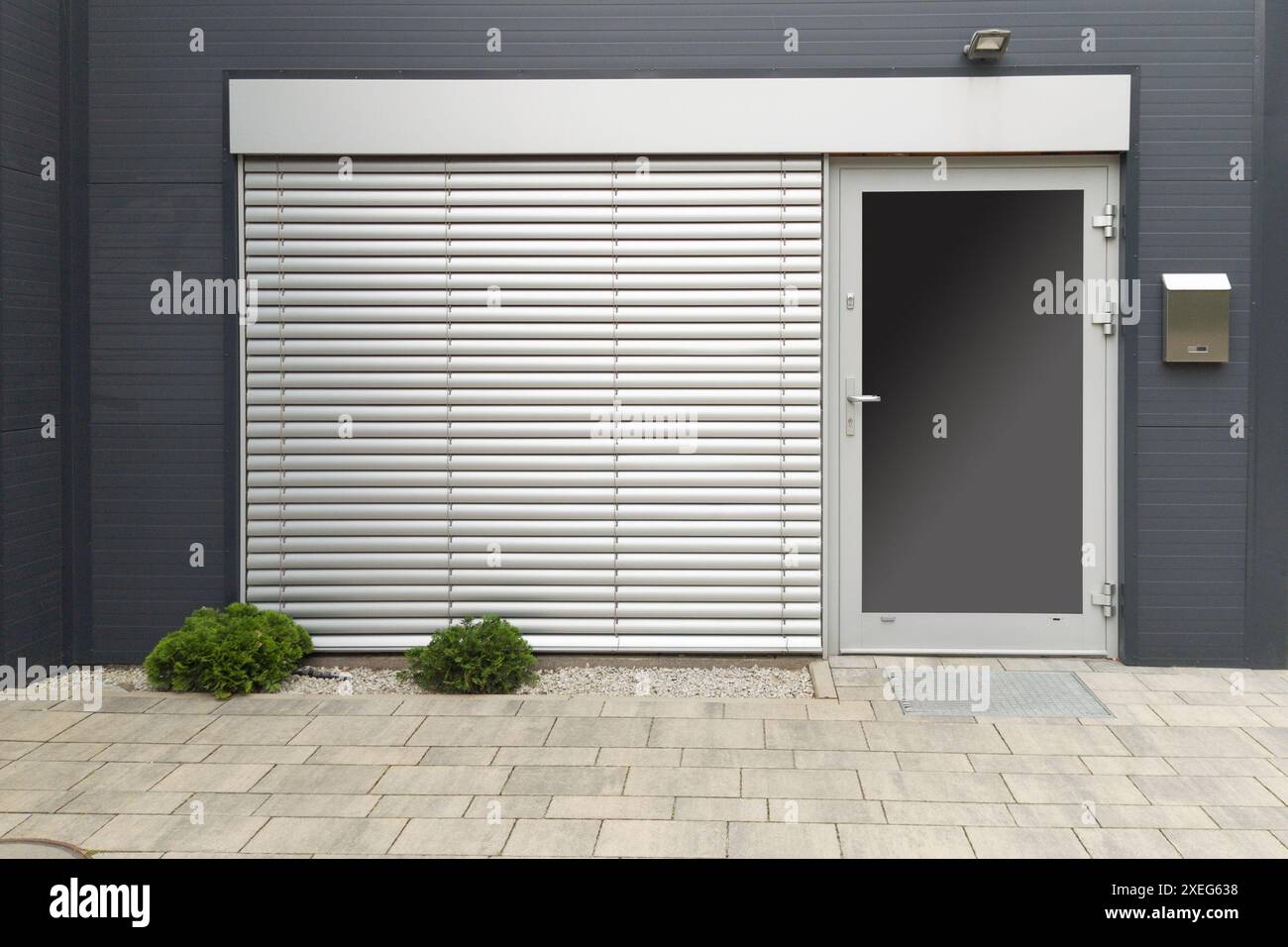 Commercial Building with Roller Shutter Door Stock Photo - Alamy