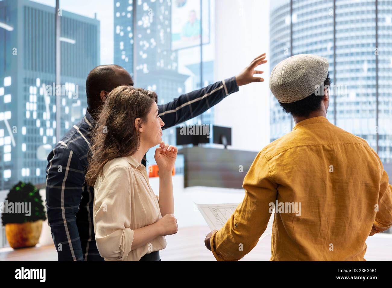 Realtor and clients sharing workspace design vision on an office tour ...