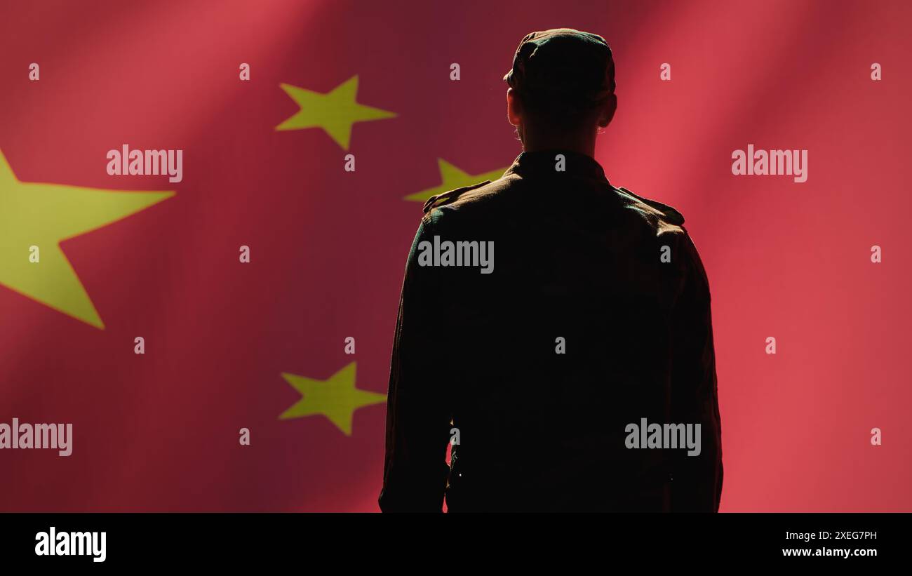 Soldier doing salute hand gesture towards Chinese flag, feeling pride ...