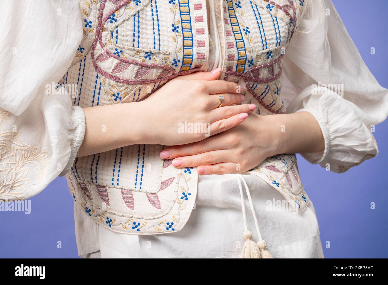 Young woman squeezing belly with hands. abdominal pain, suffering ...