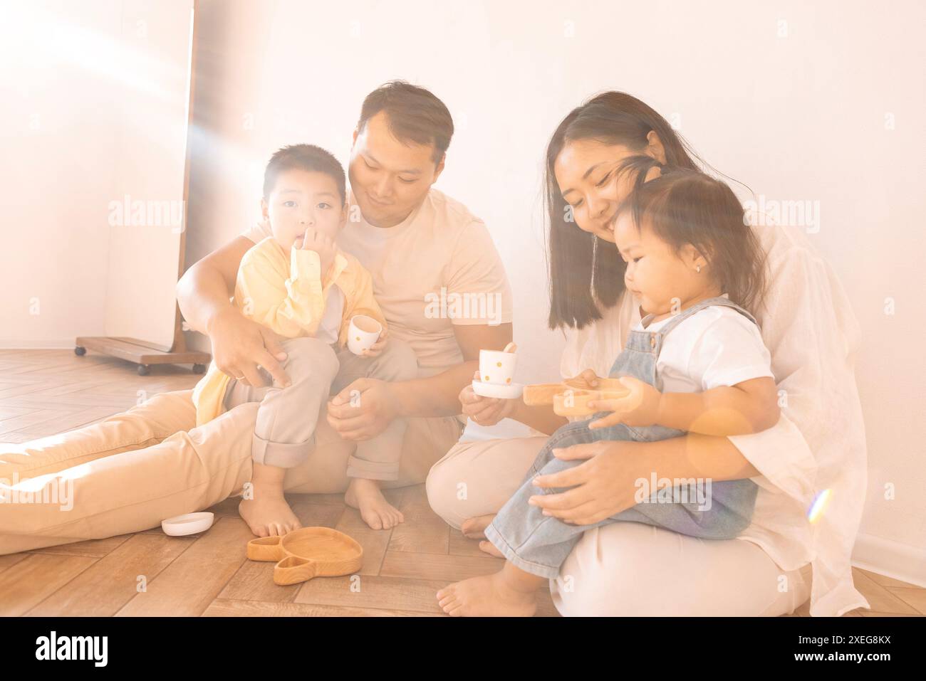A happy Asian family. Korean parents and their cute little children ...