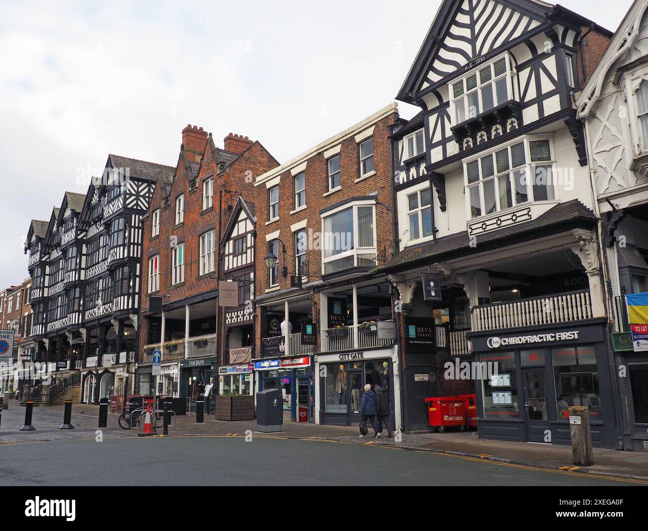 People walking past shops and bars in Bridge street Chester Stock Photo ...