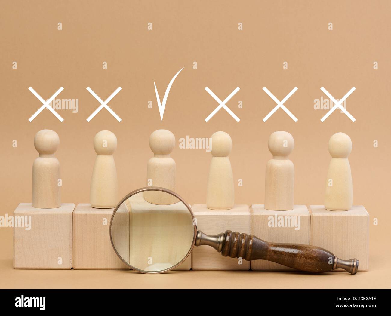 Wooden figures of men stand on a beige background and a wooden ...