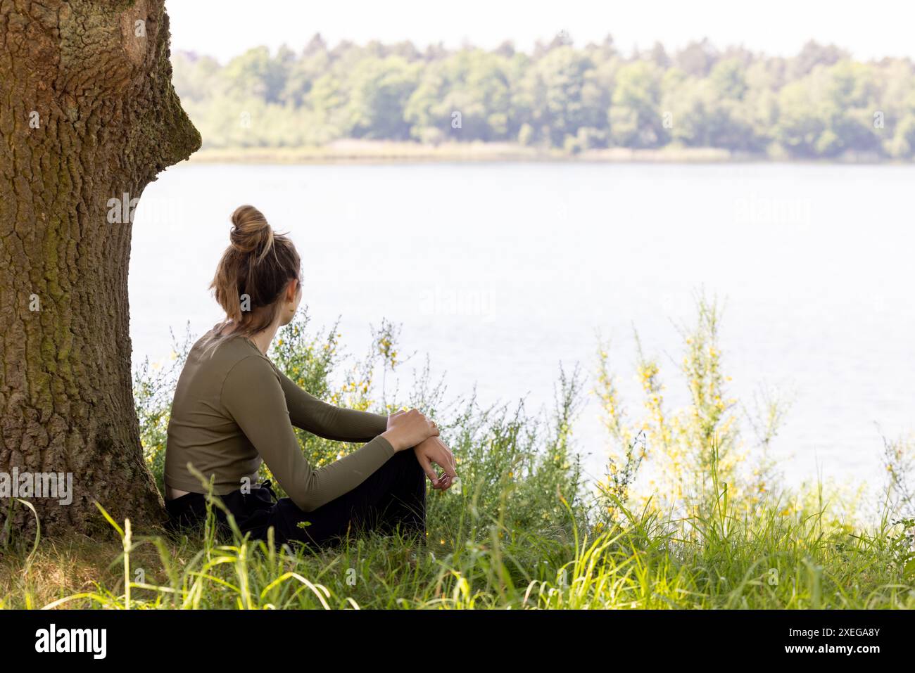 Peaceful Respite: Young Woman by the Water's Edge Stock Photo - Alamy