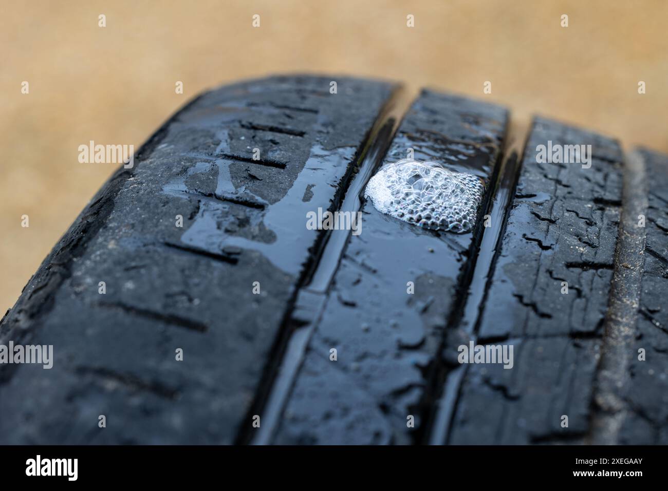 soapy water and bubbles used to locate a hole in a flat tire Stock ...