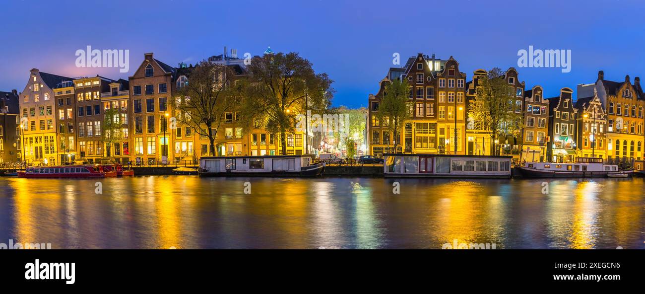 Amsterdam Netherlands, night panorama city skyline at canal waterfront ...