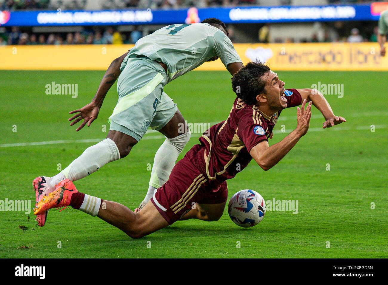 Mexico forward Julian Quiñones (9) fouls Venezuela defender Jon Mikel ...