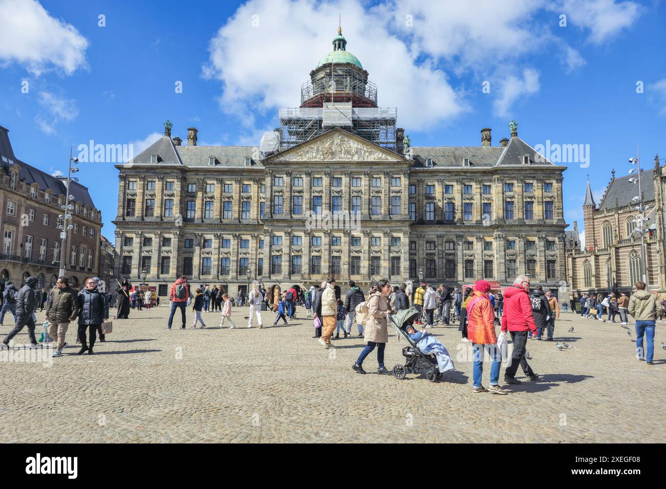 A bustling scene with a grand, towering building as the backdrop ...