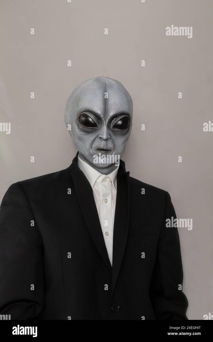 Portrait Of Alien Wearing Suit Gray Background. World UFO Day. Extra ...