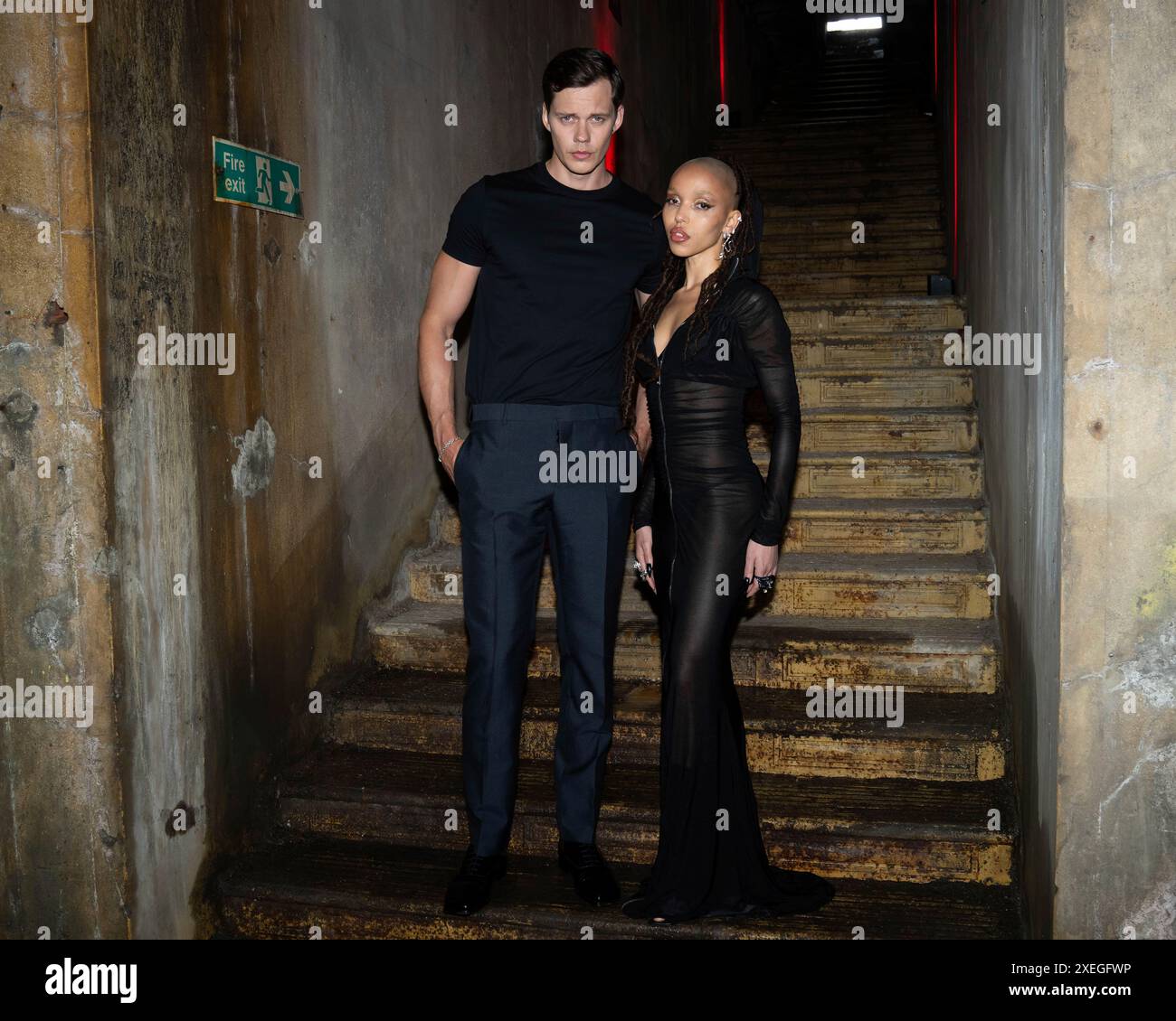 Bill Skarsgard, left, and FKA Twigs pose for photographers upon arrival ...