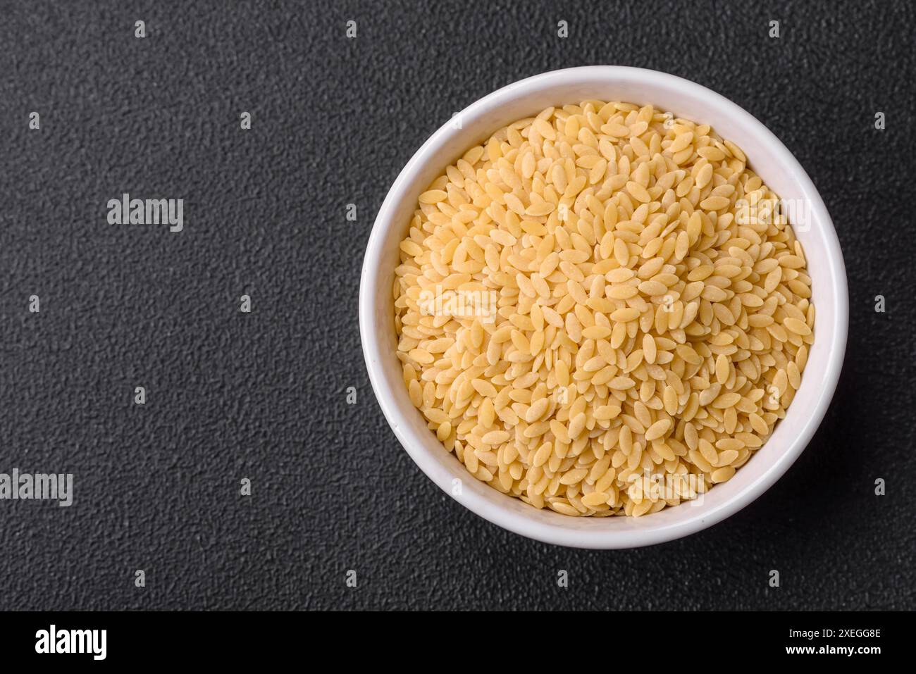 Raw whole grain orzo pasta as an ingredient for a delicious dish Stock ...