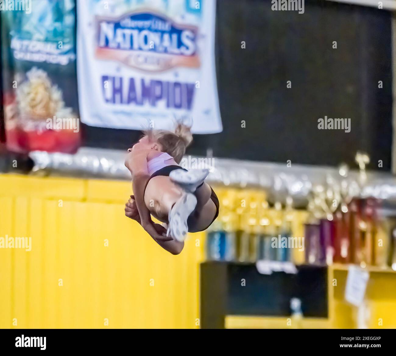 A toned gymnast perfects her routines at the gym ahead of a competition ...