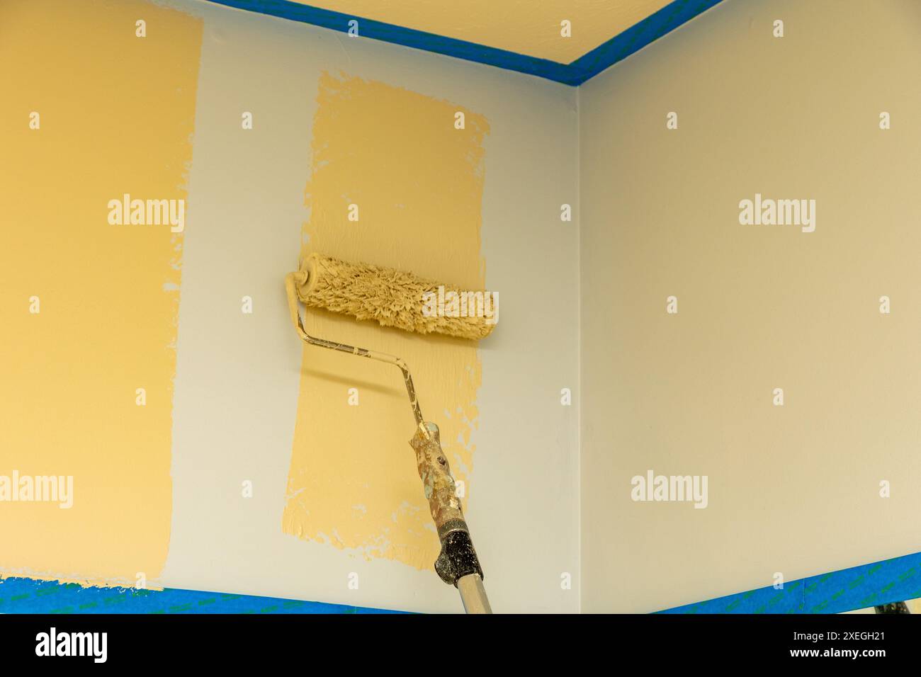 Wall getting new paint from paint roller Stock Photo - Alamy