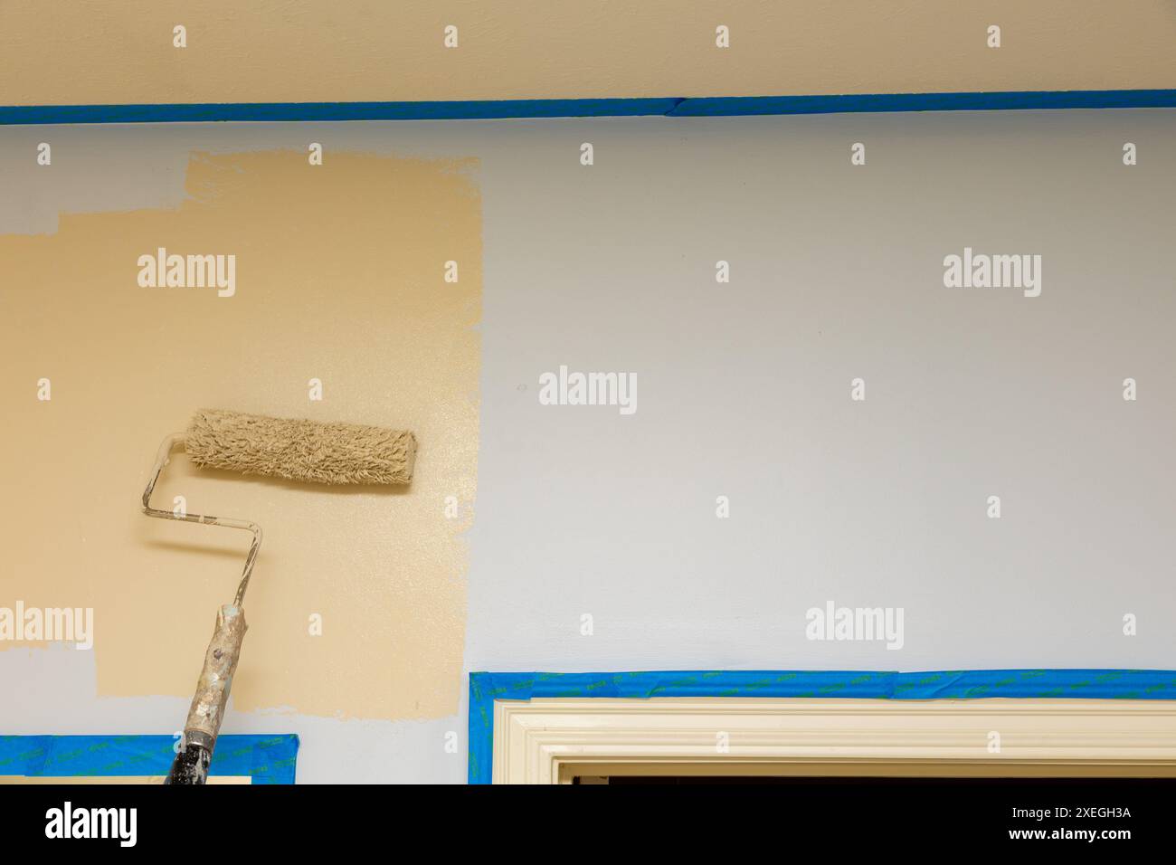 Wall getting new paint from paint roller Stock Photo - Alamy