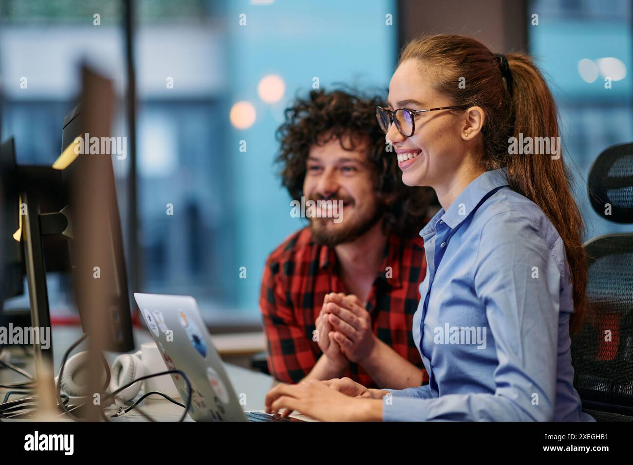 Business colleagues, a man and a woman, engage in discussing business ...