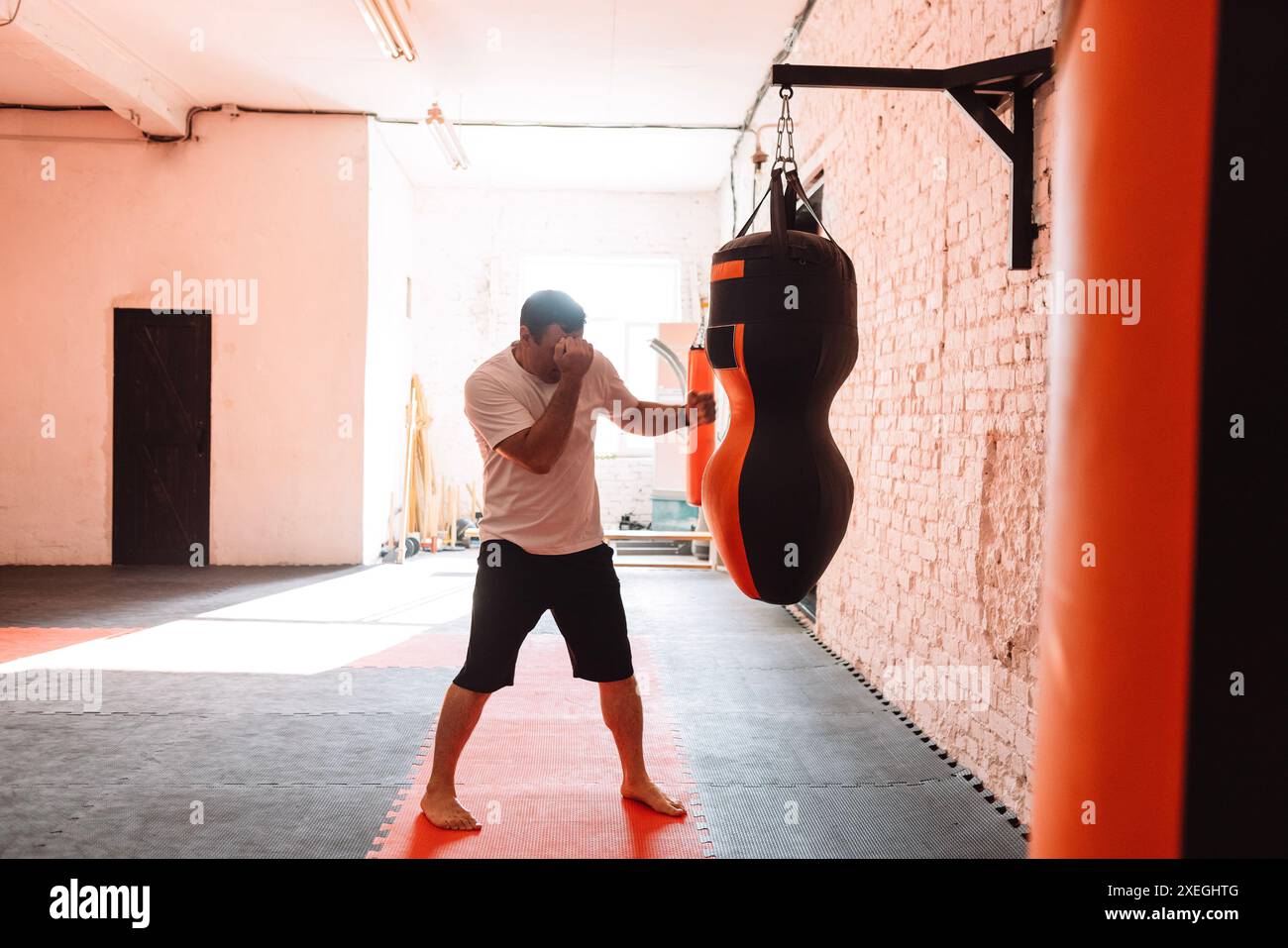 Athlete hitting heavy bag in hi-res stock photography and images - Alamy