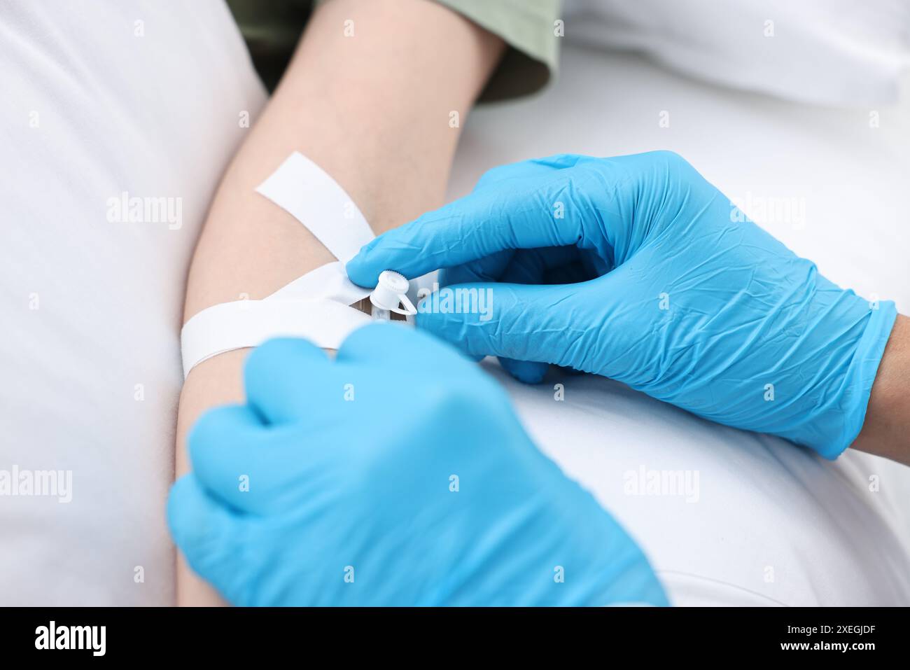 Nurse inserting IV into arm of patient in hospital, closeup Stock Photo ...