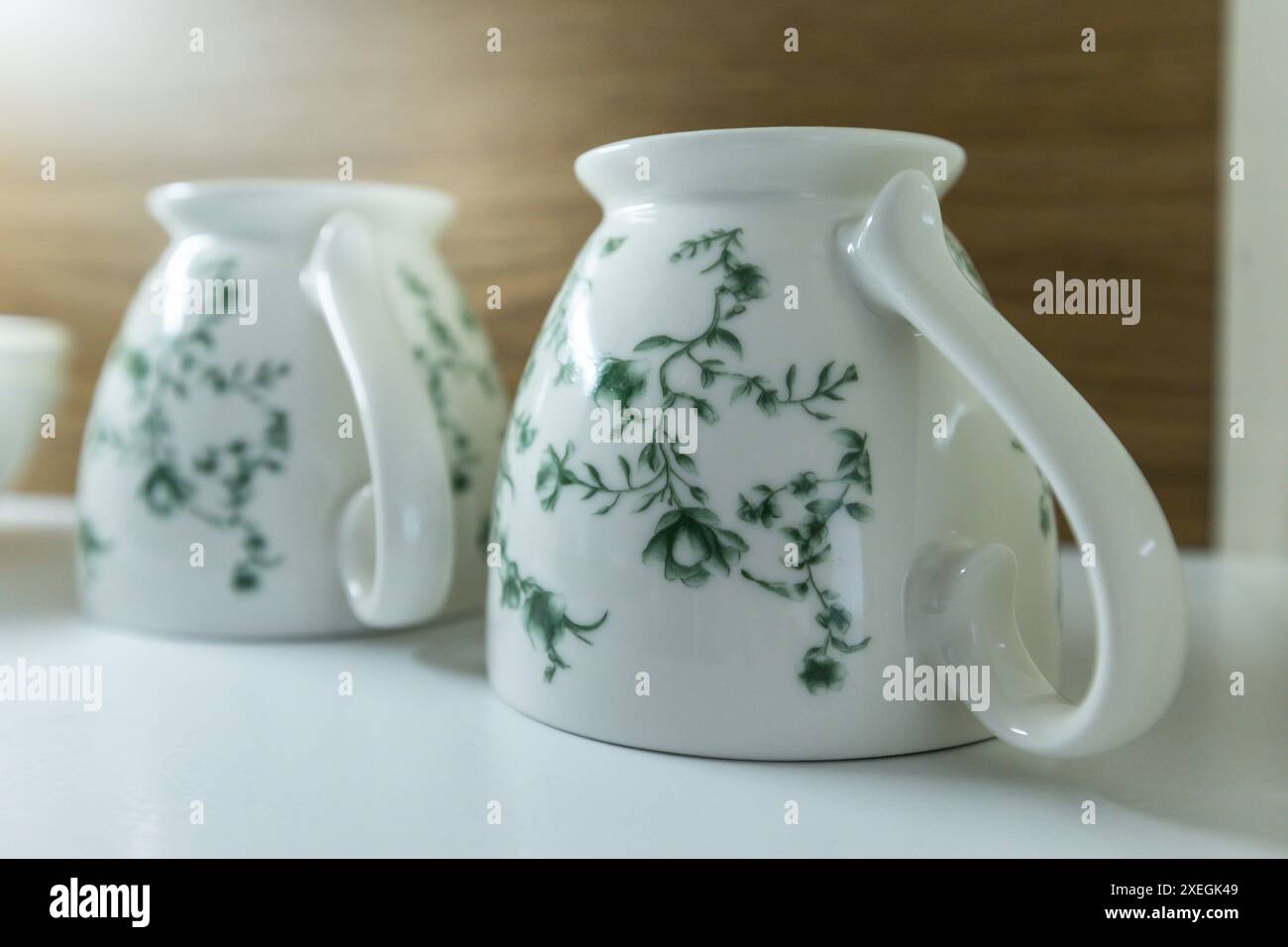 Set of clean mugs in kitchen cupboard, upside down Stock Photo - Alamy