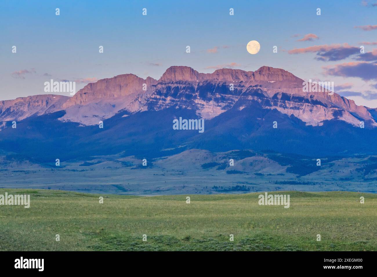 full moon setting over sawtooth ridge along the rocky mountain front ...