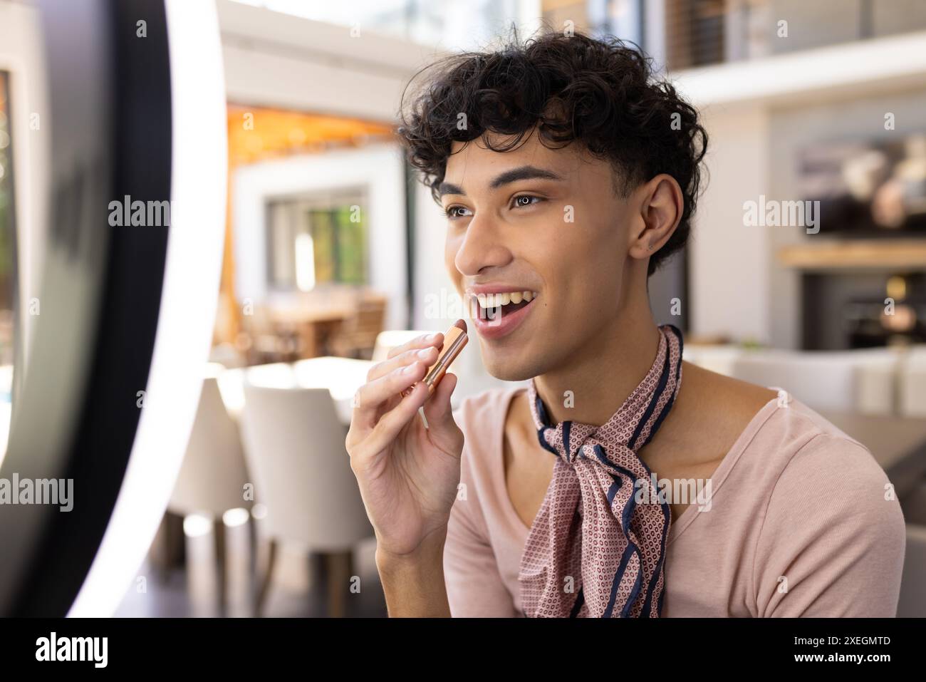 Applying lipstick, transgender transgender woman smiling in front of ...