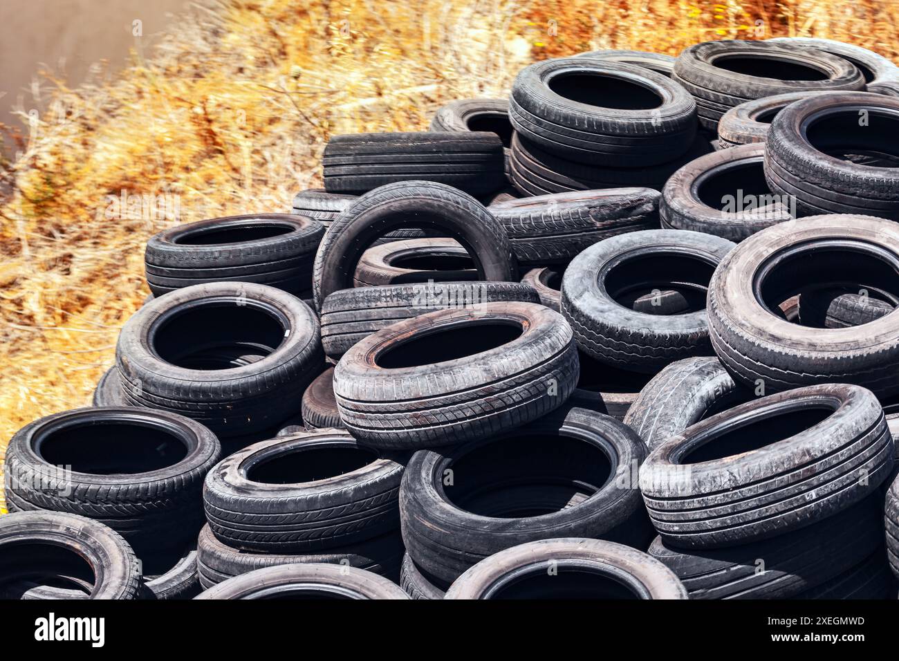 Stack of tires ready for recycling. Pile of old tires is stacked on top of each other. Concept ...