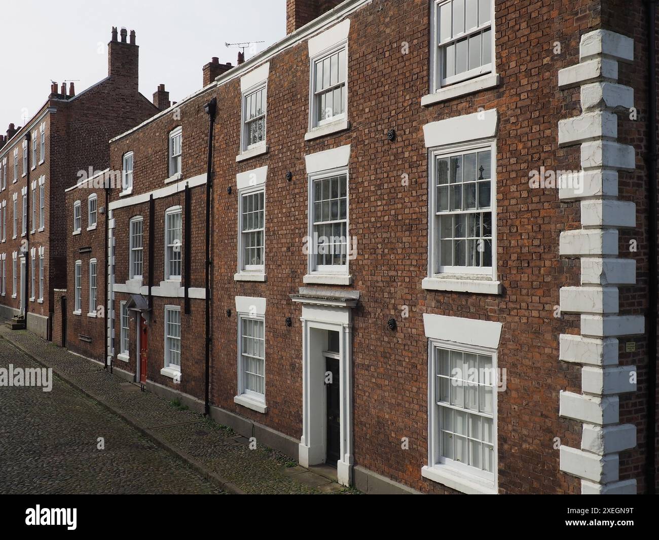 Street of old traditional red brick Georgian houses on a cobbled road ...