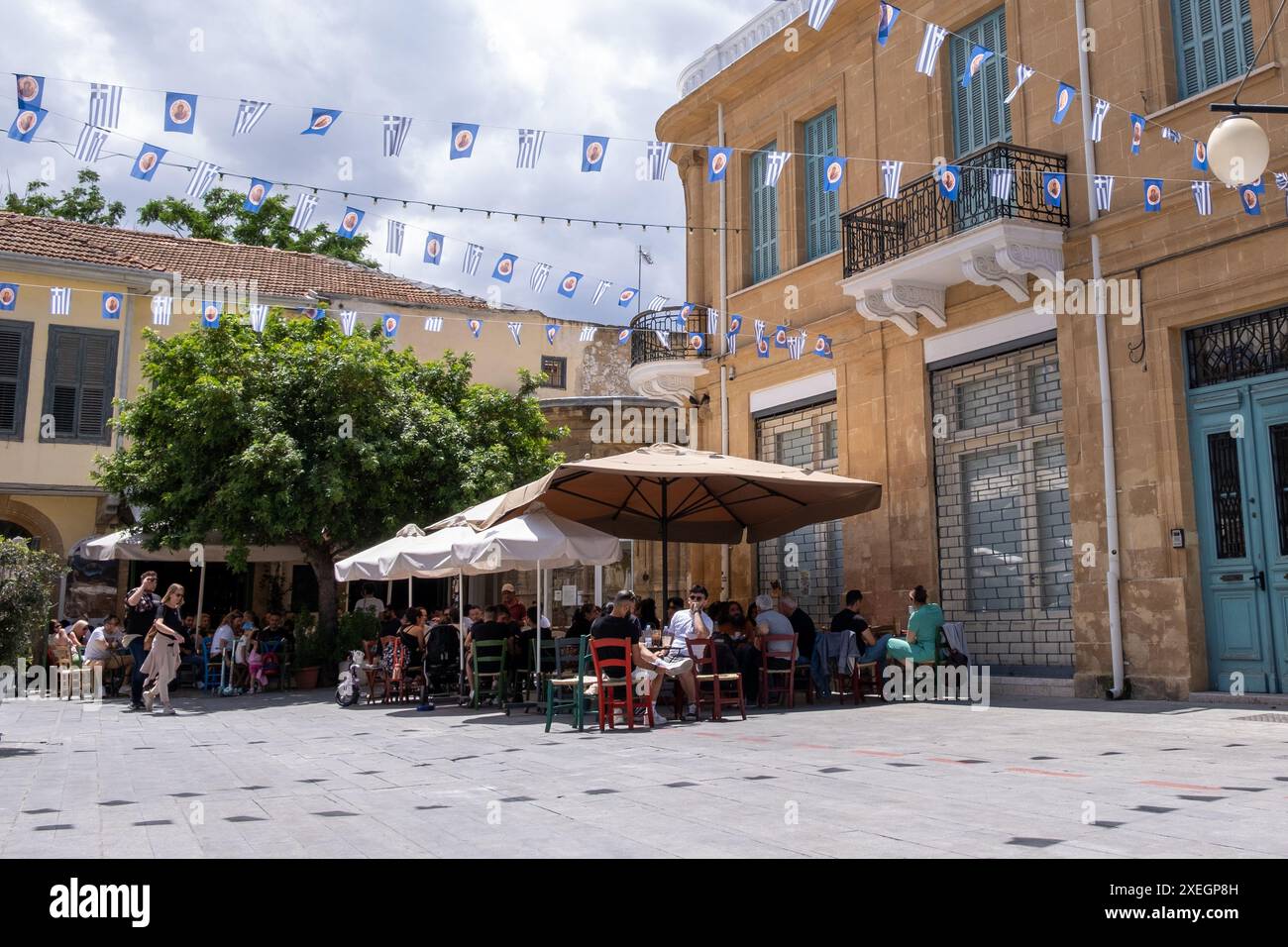 People walking and resting at coffee shops in the streets of Nicosia ...