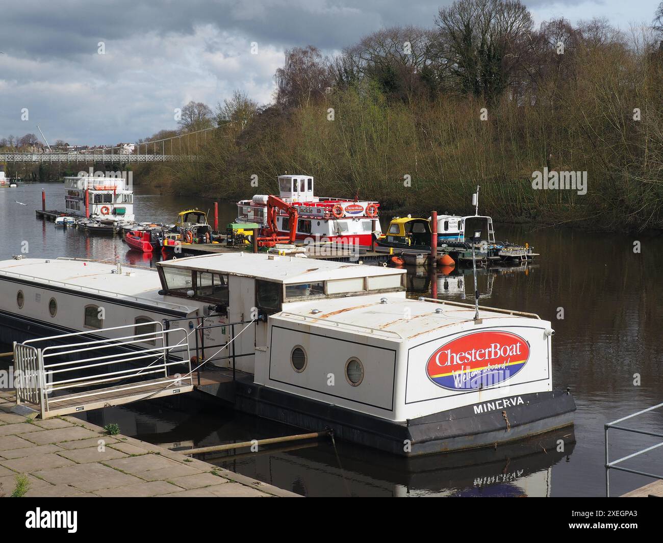 The Tour boat Minerva and landing stage on the river Dee in Chester ...