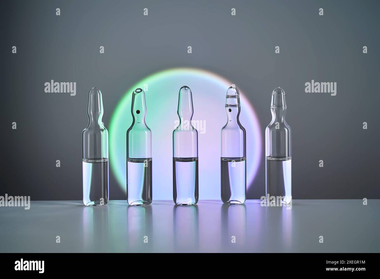 Several ampoules for injection with medicines on a blue background ...